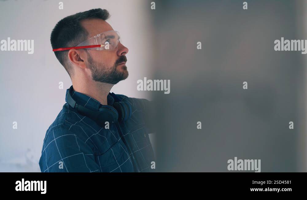 builder in shirt uses level to check wall angle in room Stock Video ...