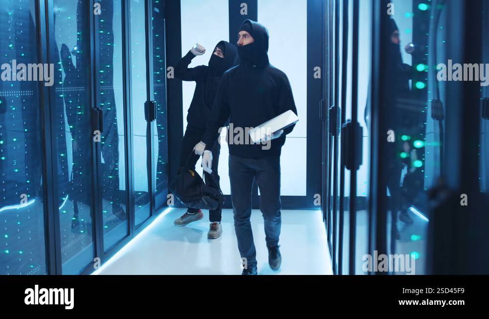 Professional spy team sneaking into secure database network storage ...