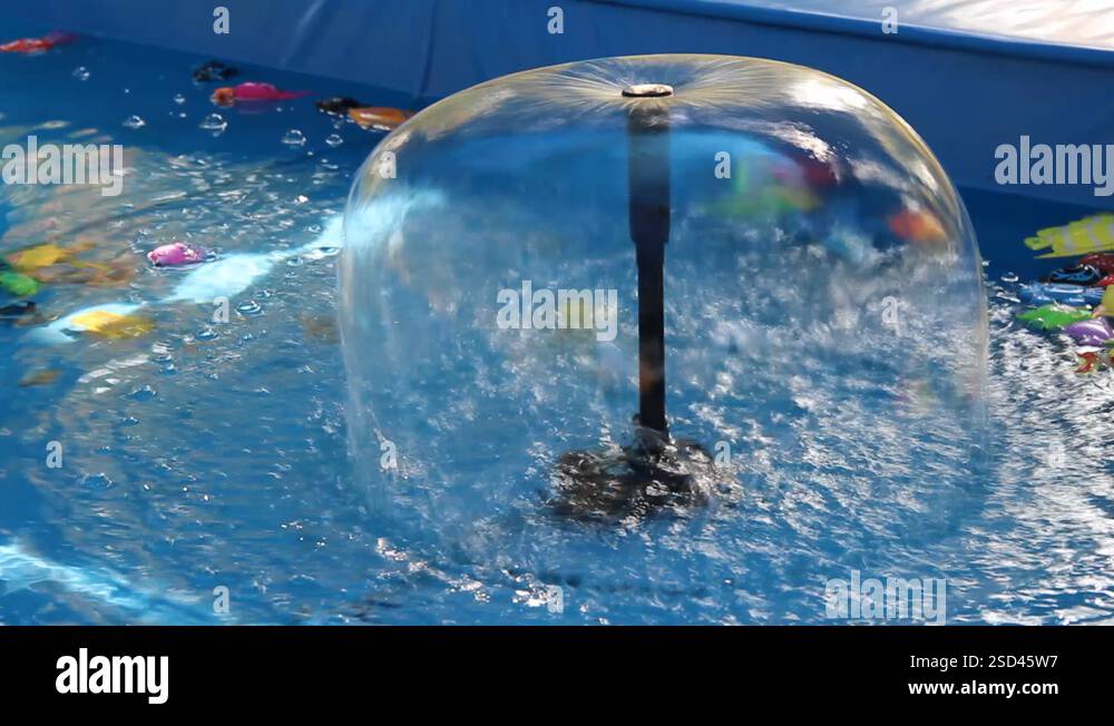 Fountainlet in a small pool. Water jets in the form of a dome in ...