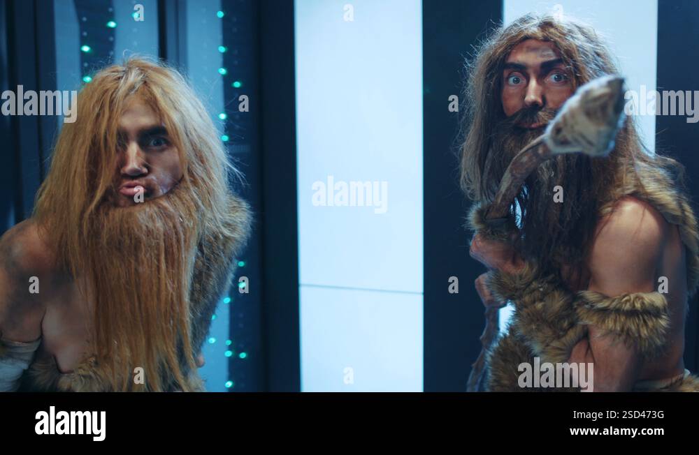 Prehistoric cavemen in animal fur growling fiercely at camera, hunting ...