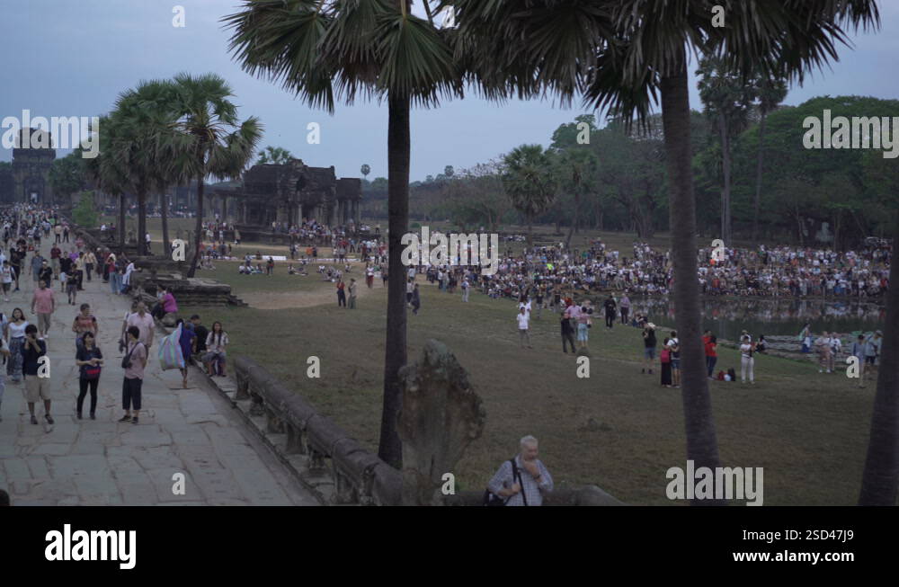 Crowd of people sightseeing ancient Angkor Wat temple ruins in Cambodia ...