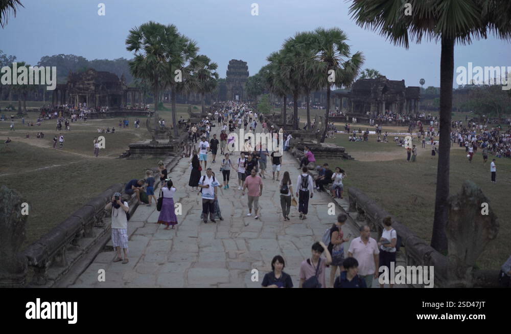 Crowd of people sightseeing ancient Angkor Wat temple ruins in Cambodia ...