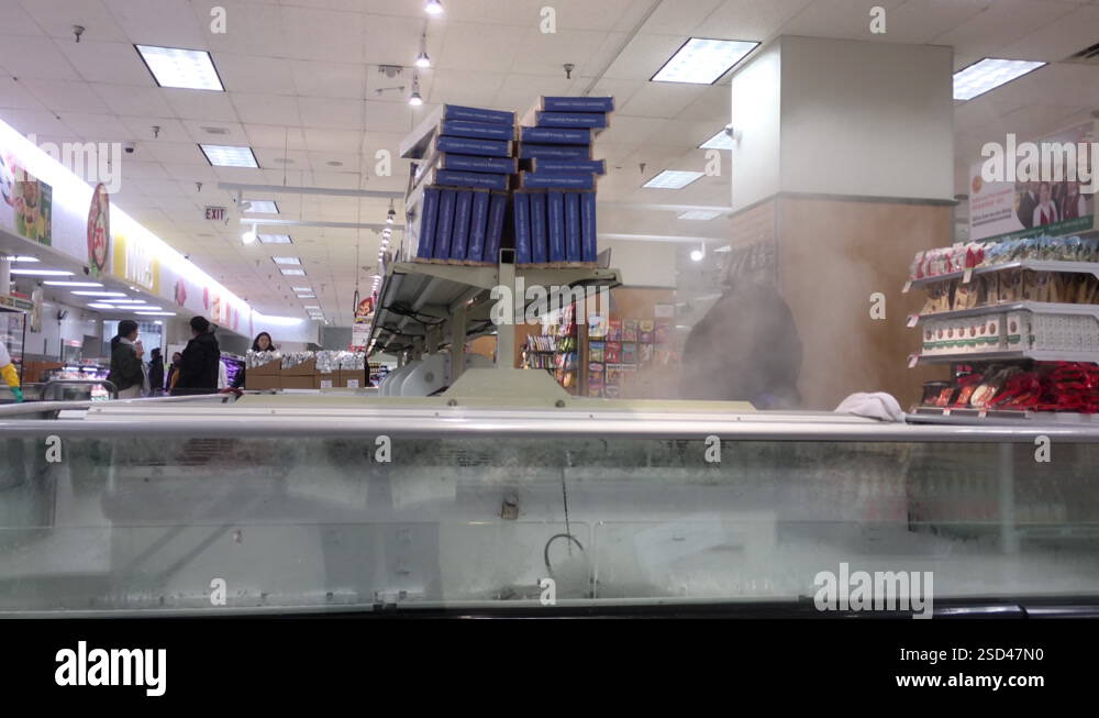 Motion of meat clerk cleaning display fridge inside T&T Chinese ...