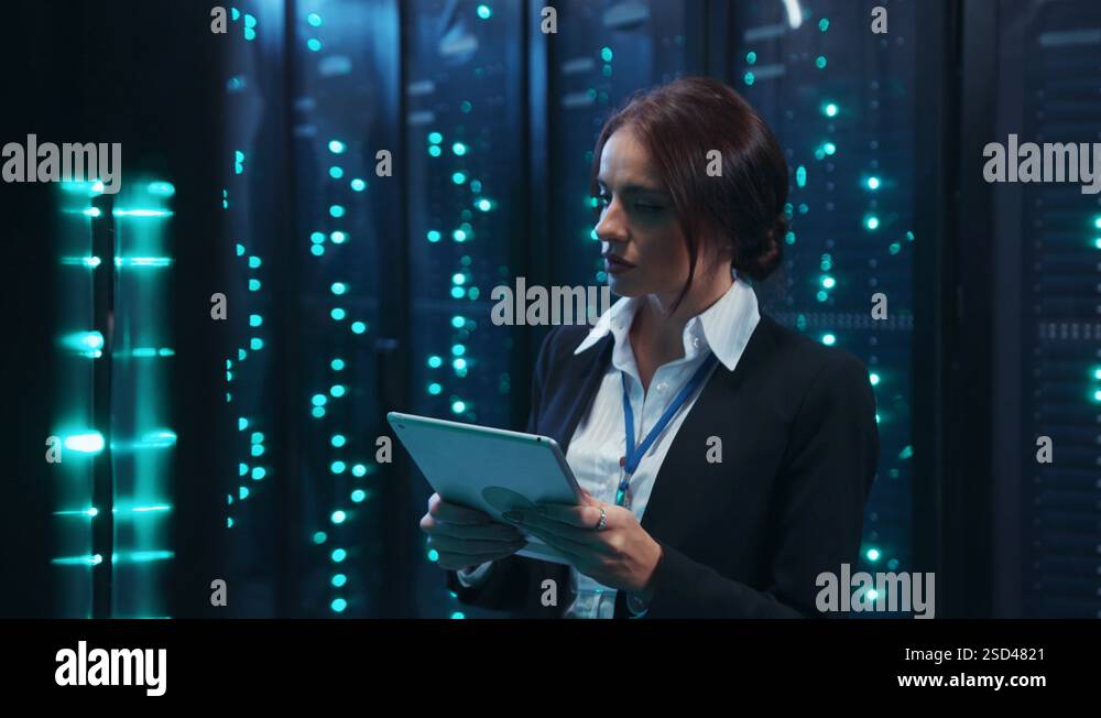 IT administrator woman working on digital laptop inspecting database center Stock Video Footage ...