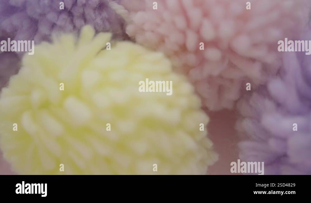 Pastel color pom poms on a pink background Stock Video Footage - Alamy