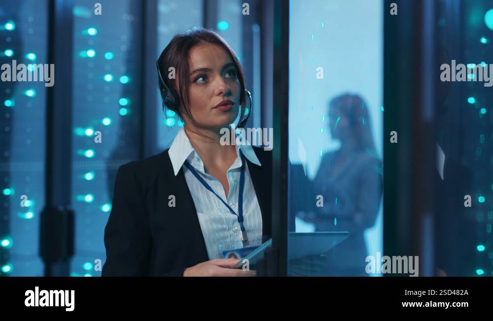 Pretty support service engineer inspecting rack server cabinet in ...