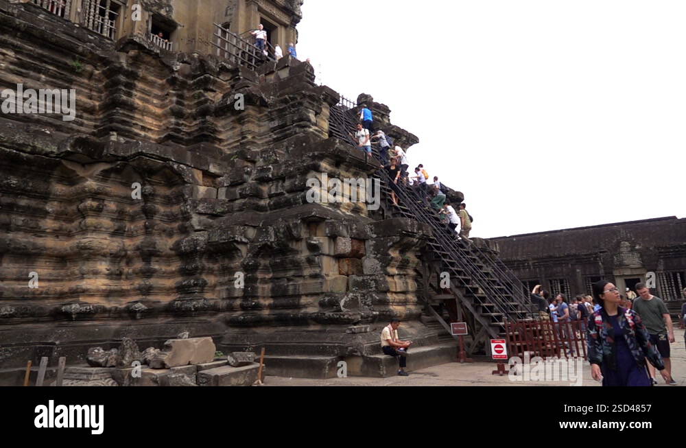 People sightseeing ancient Angkor Wat temple ruins in Cambodia, slow ...