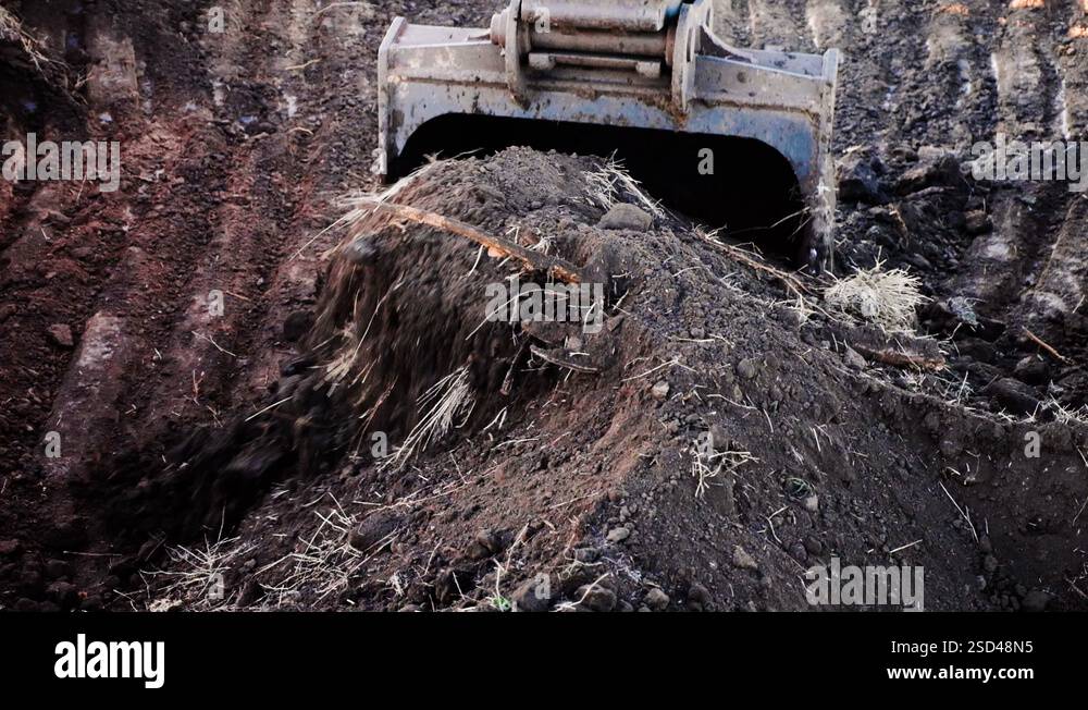 The excavator digs the earth. Bucket of tractor Stock Video Footage - Alamy