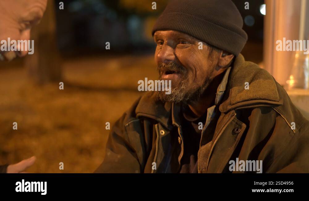 Passerby talking to homeless man on the sidewalk at night Stock Video ...