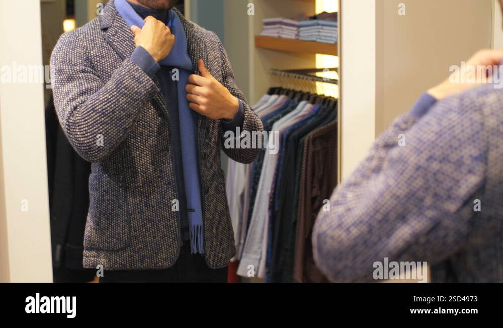 Man trying on clothes at wear shop Stock Video Footage - Alamy