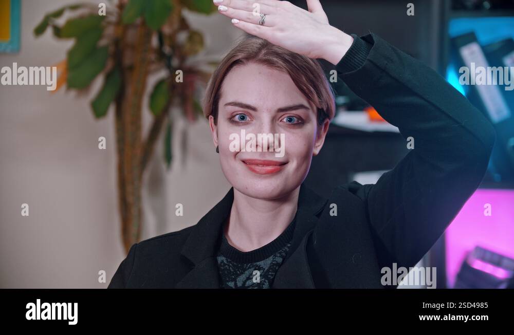 A business woman showing emotions - holds palm in front of the face ...