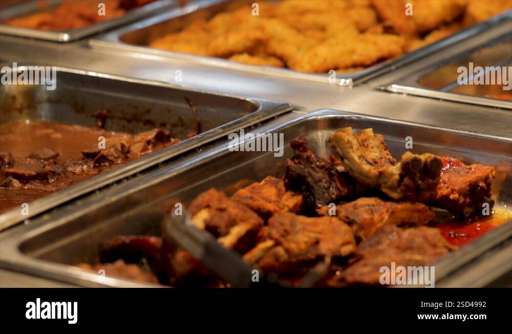 Buffet of hot food yummy beef dishes and other catered foods. Close up ...