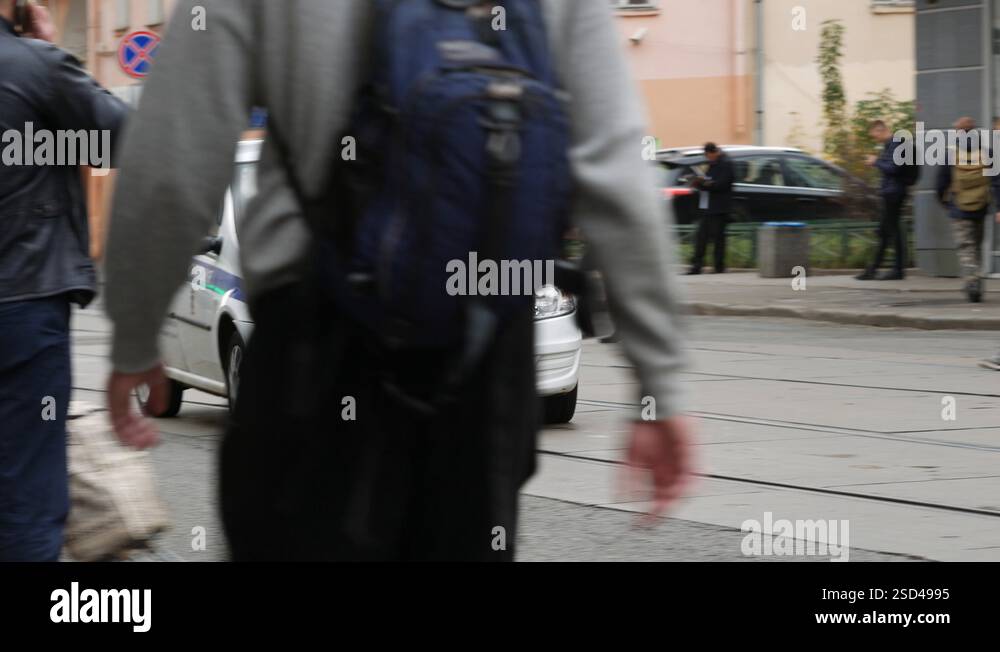 A police car rides on tram tracks. Police in a white car with flashing ...