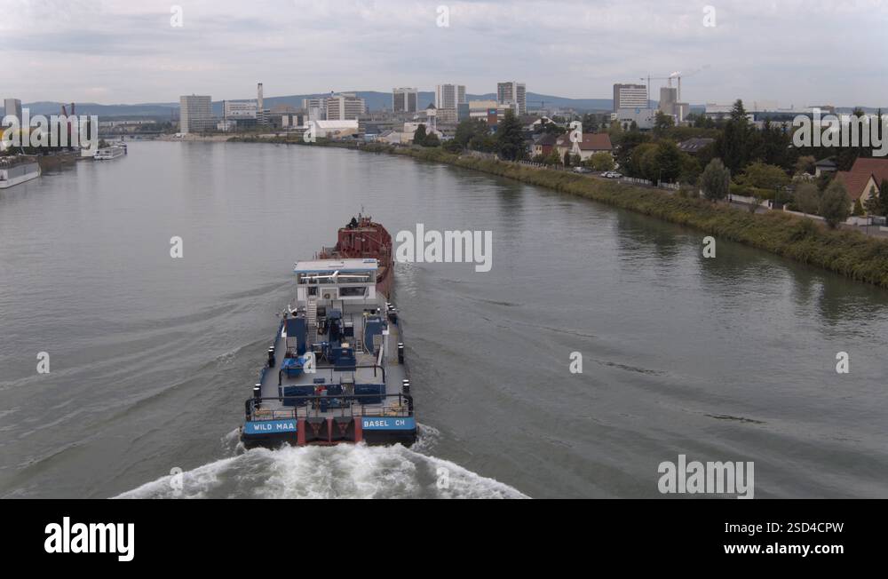 Colored tugboat works in port. bright tugboat in blue water. industrial ...