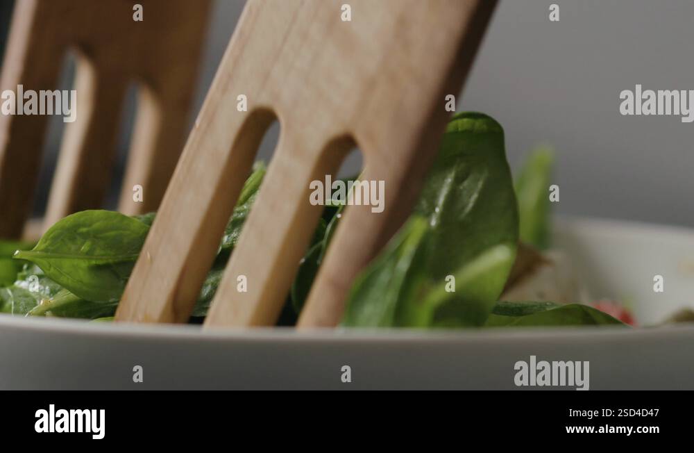 Slow motion man hands mixing salad with tomatoes, mozzarella and ...