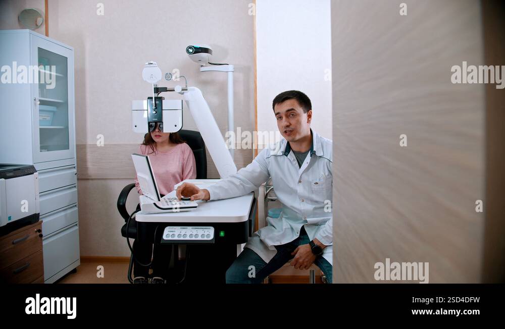 Ophthalmology treatment - young woman checking her visual acuity with ...