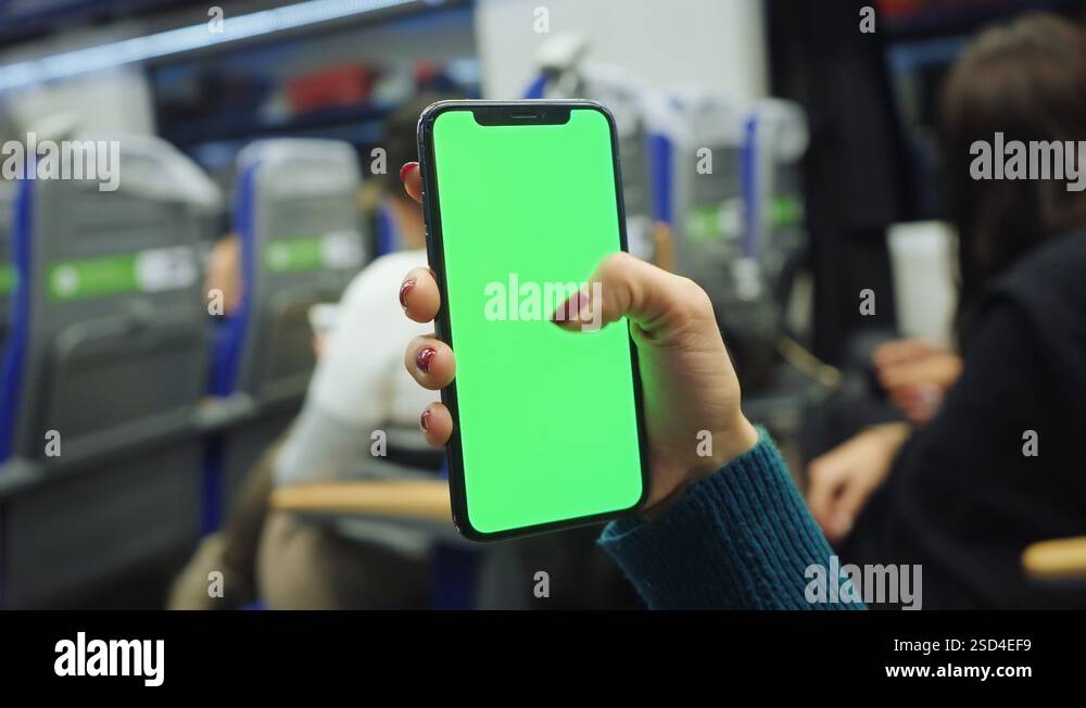 Shot of hands woman use vertical green screen phone sitting in bus ...