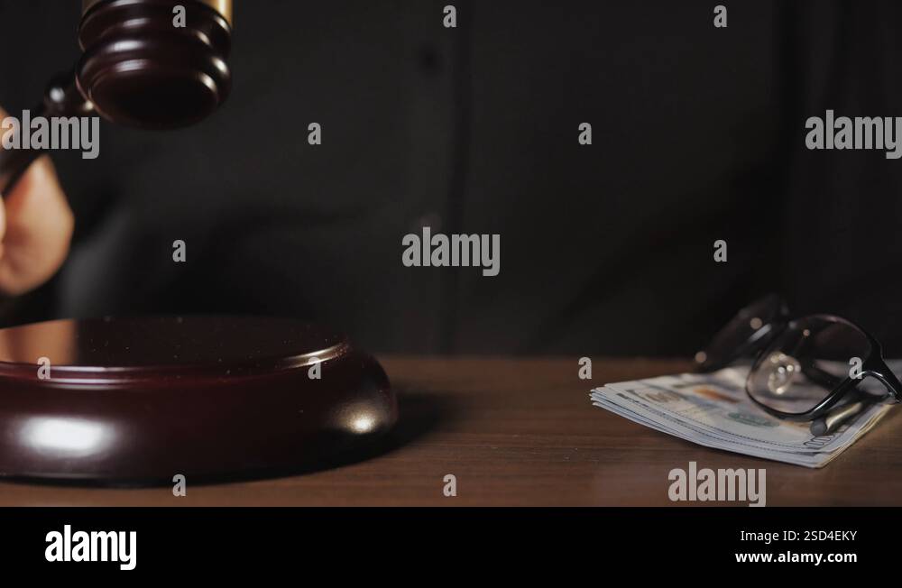 The concept of bribery in court. Close-up judge knocking on gavel. Next ...