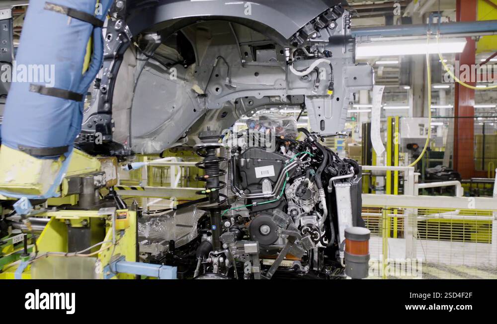 Mounting a car engine under the car hood. Automotive manufacturing ...