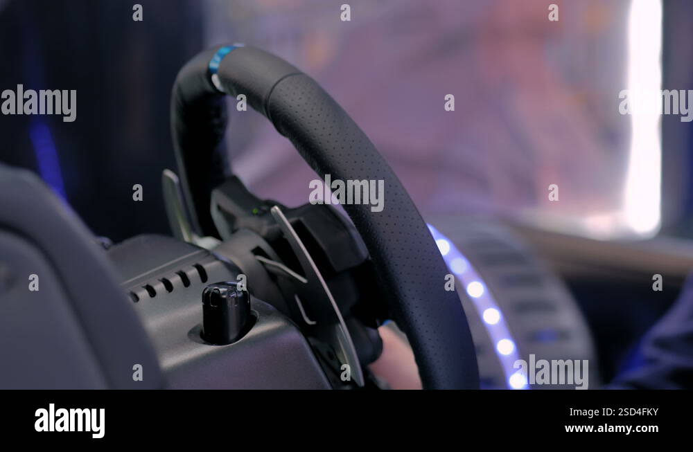 Woman using gaming steering wheel joystick at technology exhibition ...