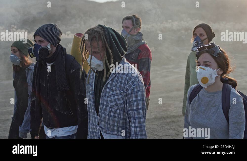 Group of young exhausted people in gas mask going through the toxic ...