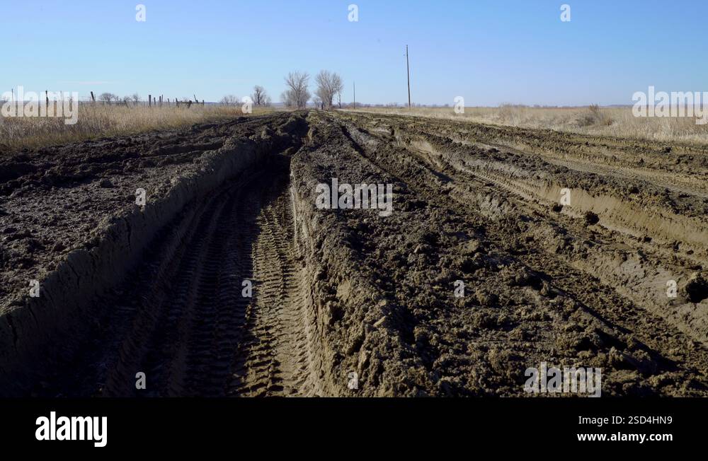 Low angle dolly of muddy ruts in prairie gumbo ranch road Stock Video ...