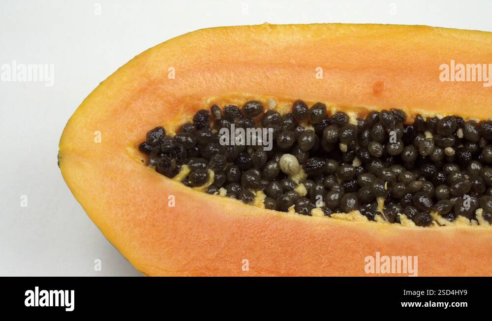Exotic papaya fruit close-up. Cut into two parts papaya with black ...