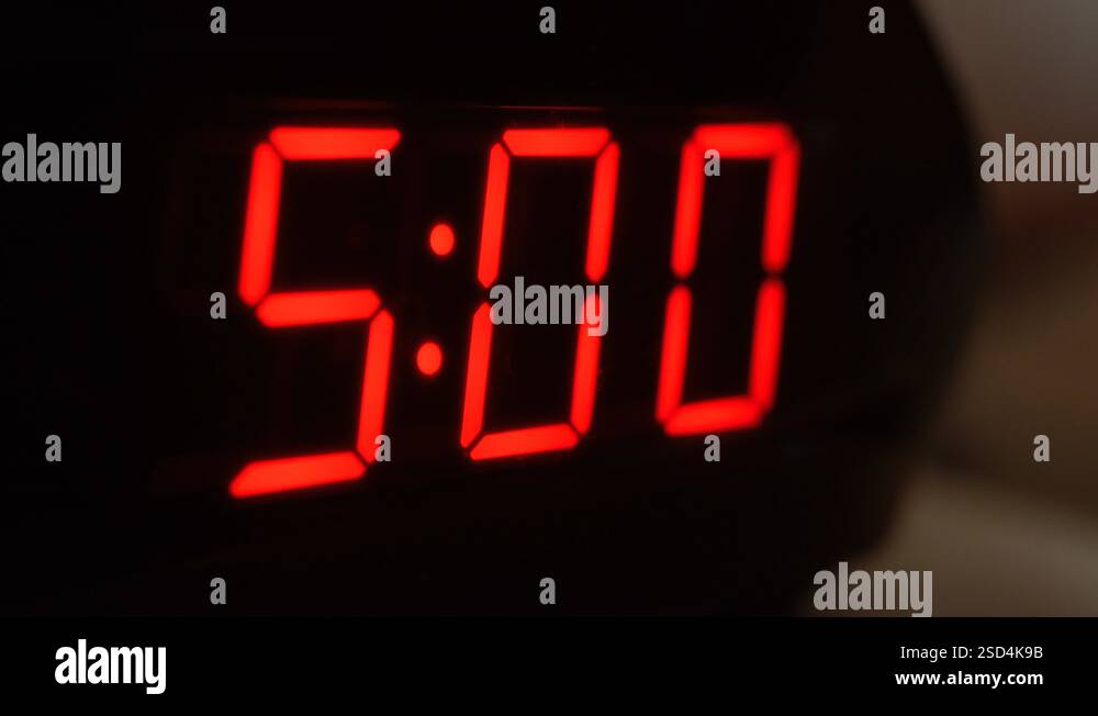 Close-up of black digital clock screen showing 5.00. Modern timer ...