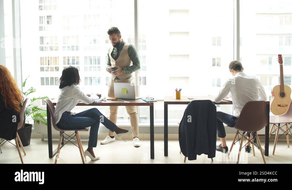 Office staff of different races and genders enjoying relaxed and ...