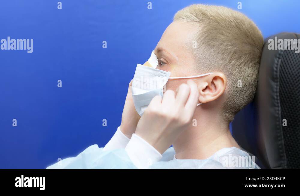 female patient after rhinoplasty takes medical face mask. blood ...