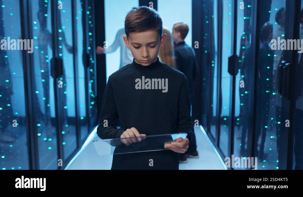 Young prodigy boy using an innovation transparent tablet running ...