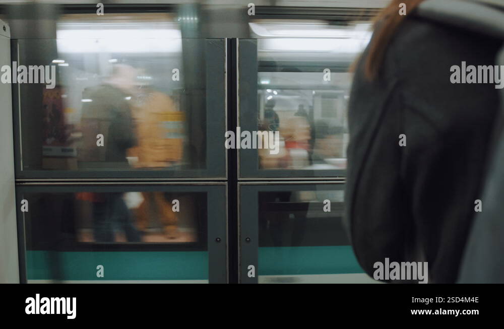 Cinematic close-up camera follows woman waiting for metro train at ...