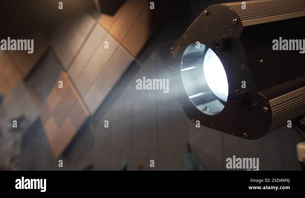 Closeup view of big cinema spotlight and dust floating in the air seen ...