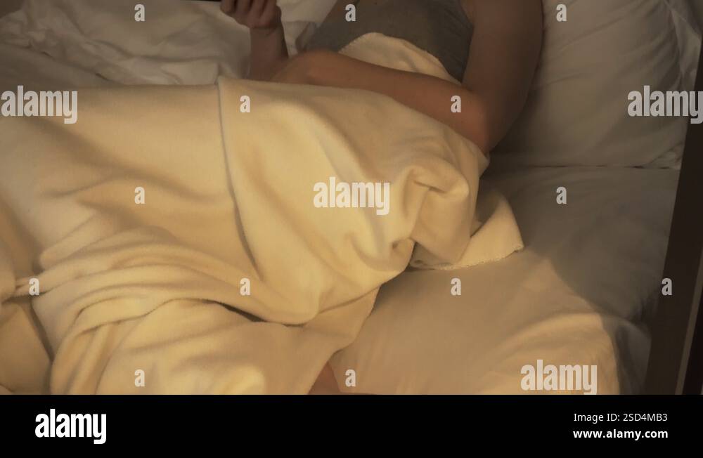 A young girl sits on a bed in a sleeping state Stock Video Footage - Alamy