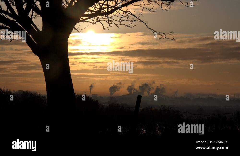 Industrial landscape in North England with chimneys and smoke with tree ...