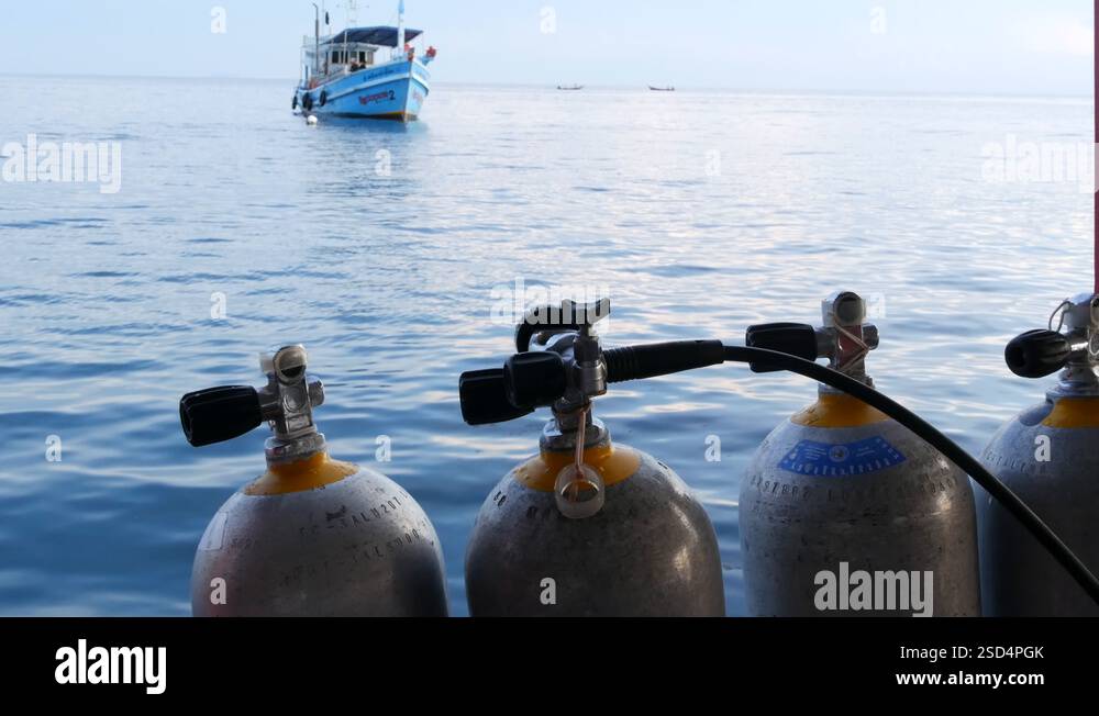 Row of oxygen tanks and diving equipment placed on modern boat in ...