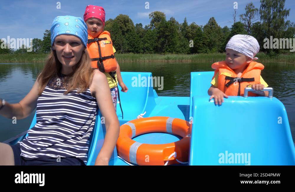 Son daughter and mother in life jackets float on catamaran boat. Gimbal ...