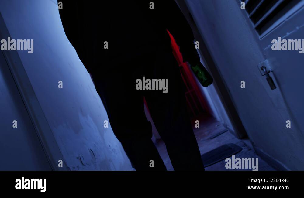 Alcoholic male stumbling in decrepit ghetto building corridor Stock ...