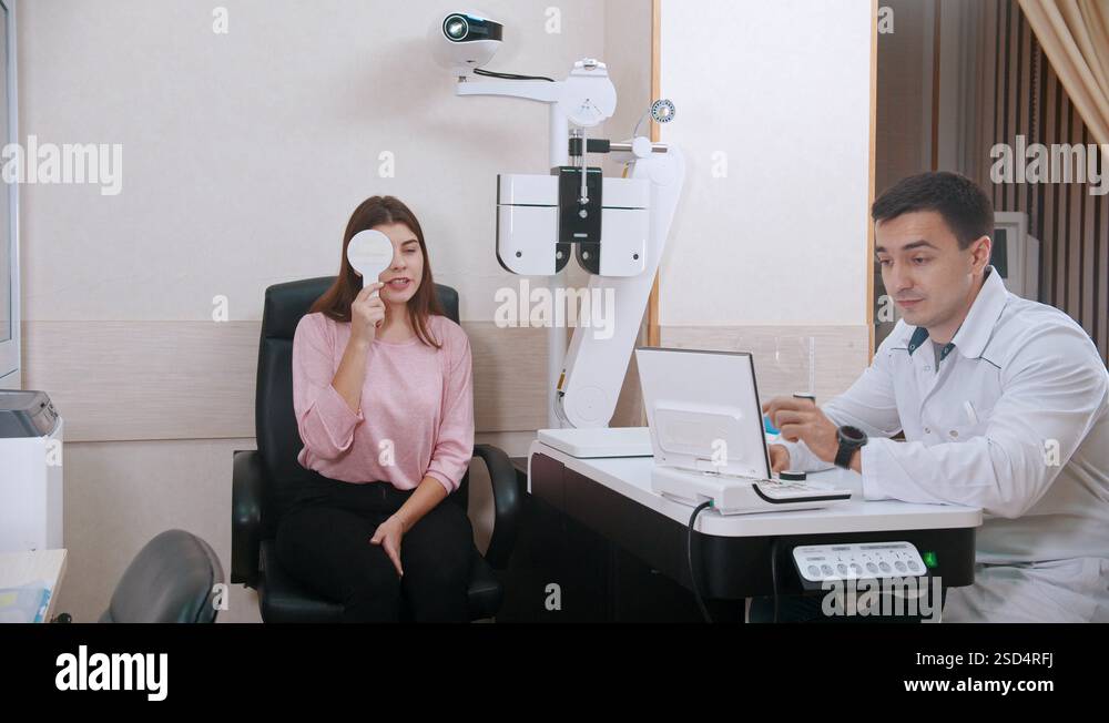 Ophthalmology treatment in the bright cabinet - young woman checking her visual Stock Video ...