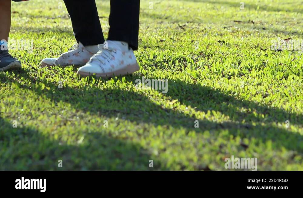 Close-up Shadow of people running on grass. Asian family happy relaxed ...