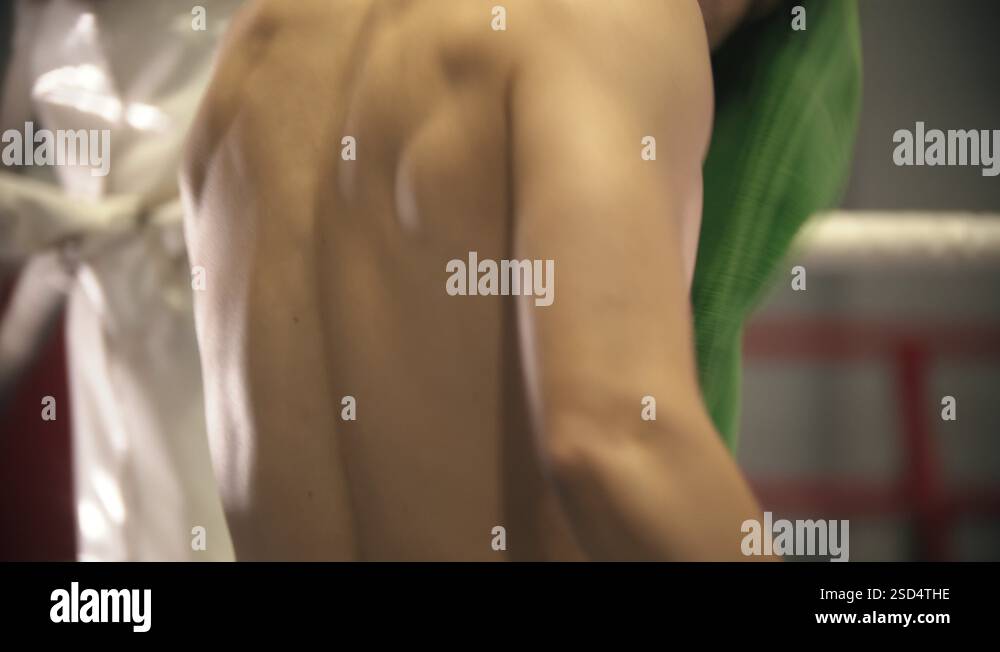 Box training - a tired man sit on the corner of the ring and takes the ...