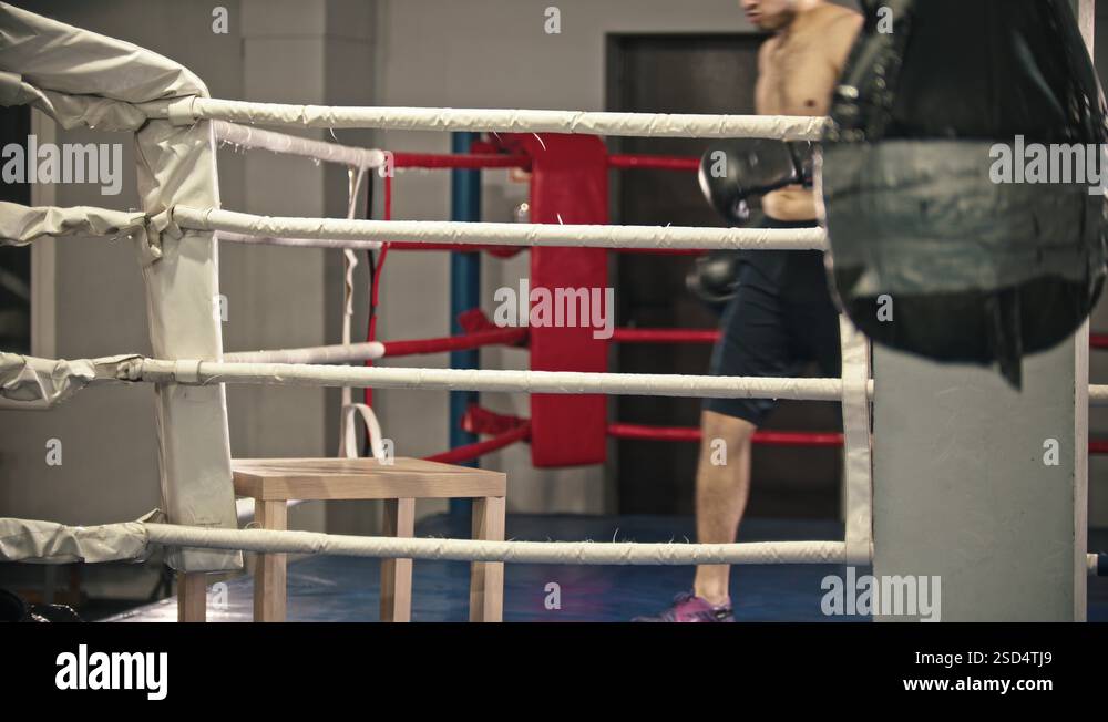 Box training - a tired man sit on the corner of the ring on the chair ...