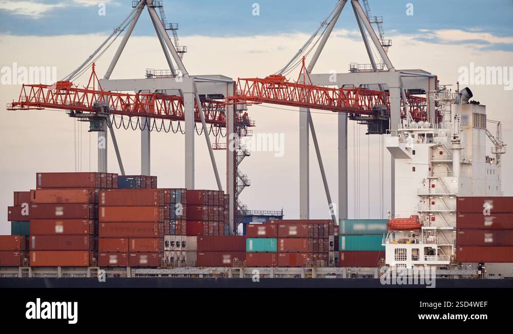 A gantry cranes unloading container ship Stock Video Footage - Alamy