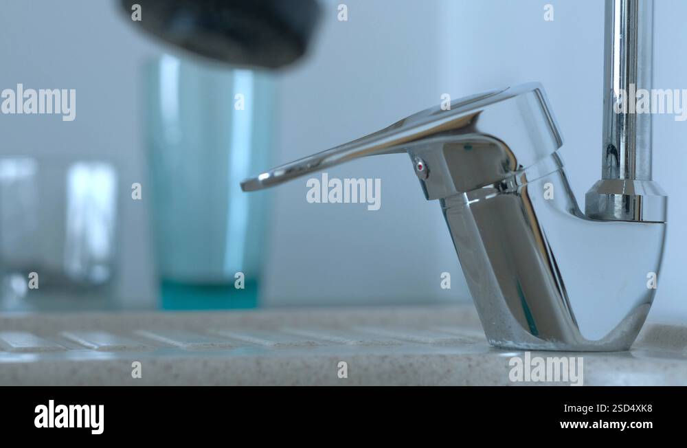 Tap water flows from tap in kitchen Stock Video Footage - Alamy