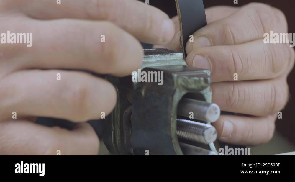 Closeup Of A Craftsman's Hand On A Leather Clamping A Piece Of Leather ...