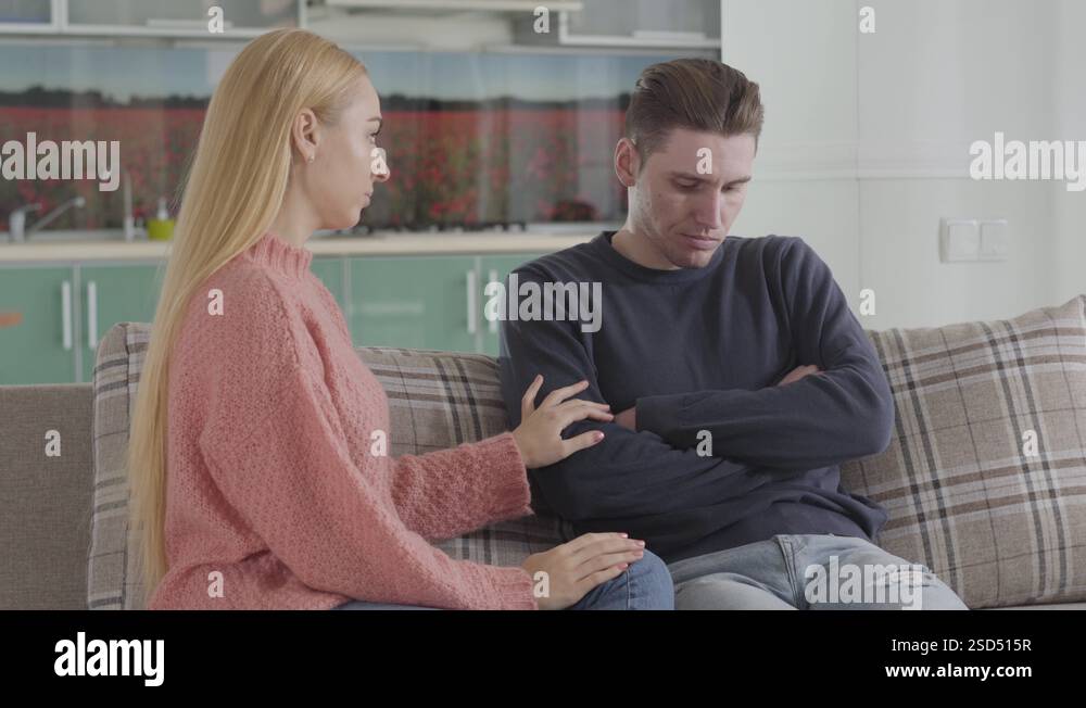 Sad Caucasian woman trying to kiss husband, man turning away. Wife calming down Stock Video ...