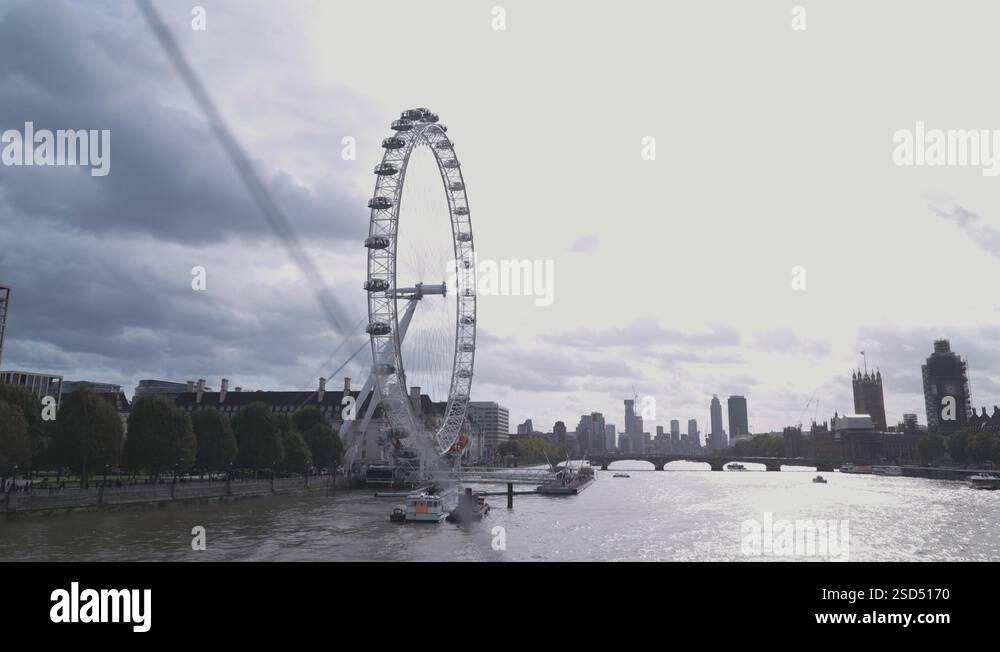Moving shot of London Eye view from Hungerford Bridge and Golden ...