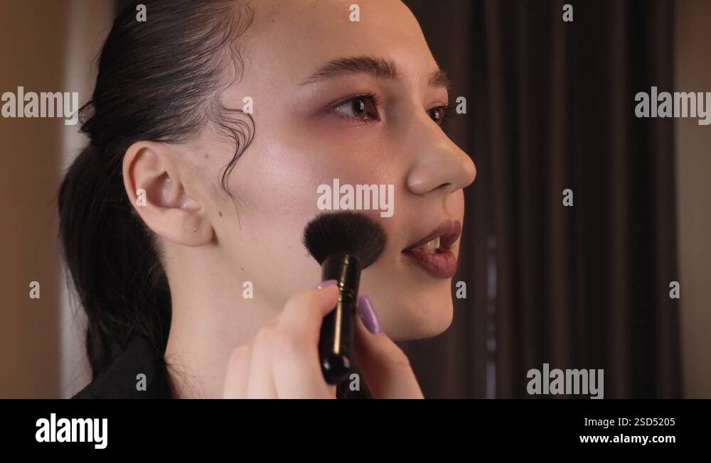 The face of a young woman close-up. Professional makeup is applied to a ...