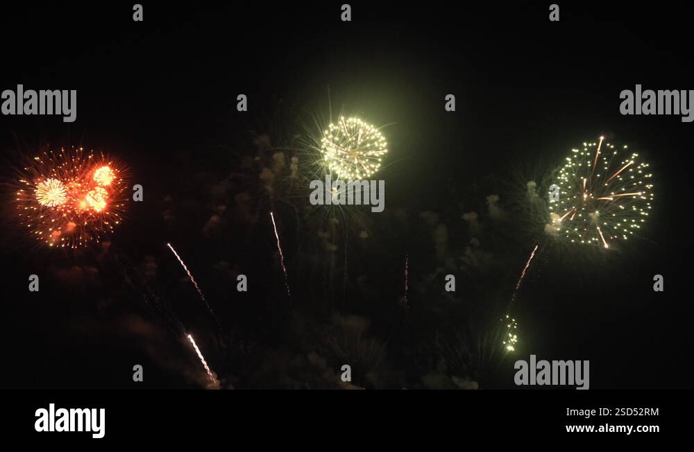 4k. Golden big shiny fireworks with bokeh lights in the night sky Stock ...