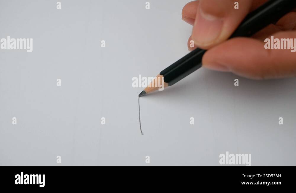 Artists hands drawing a flat line with a black pencil on paper Stock ...